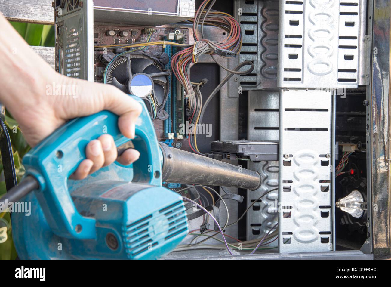 Cleaning a dusty computer with a blower Stock Photo - Alamy