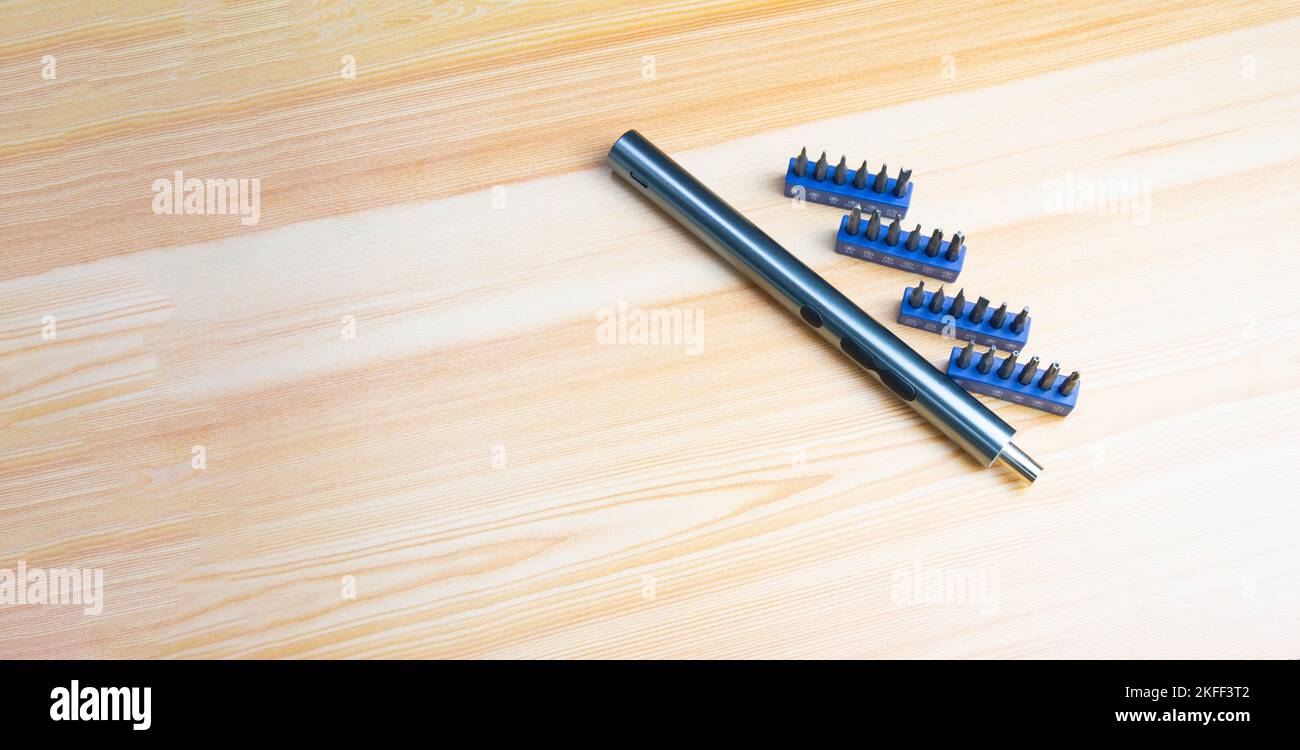 Picture of a mini electric screwdriver, interchangeable tip, placed on ...