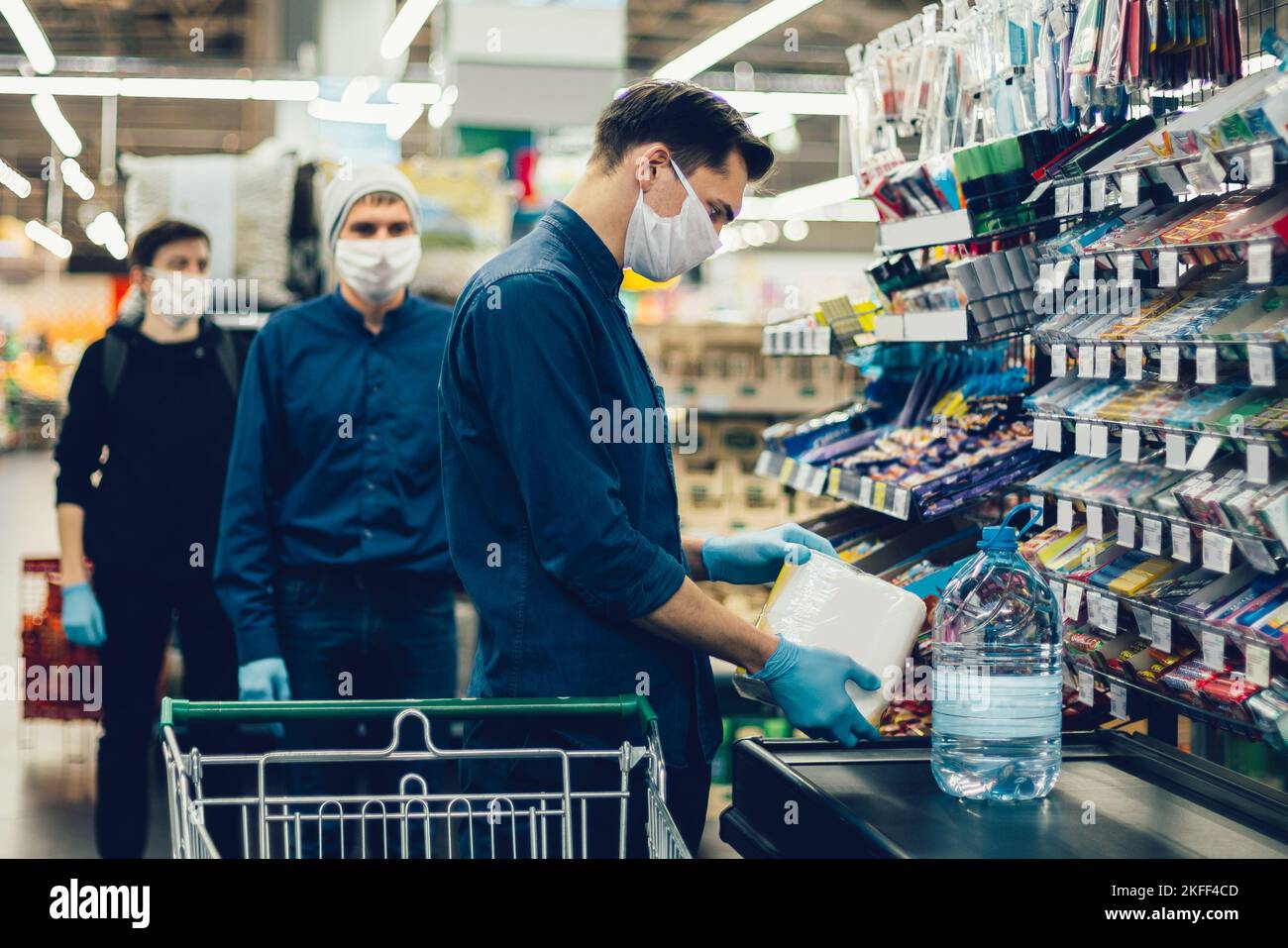 customer puts their purchases on the supermarket counter Stock Photo ...