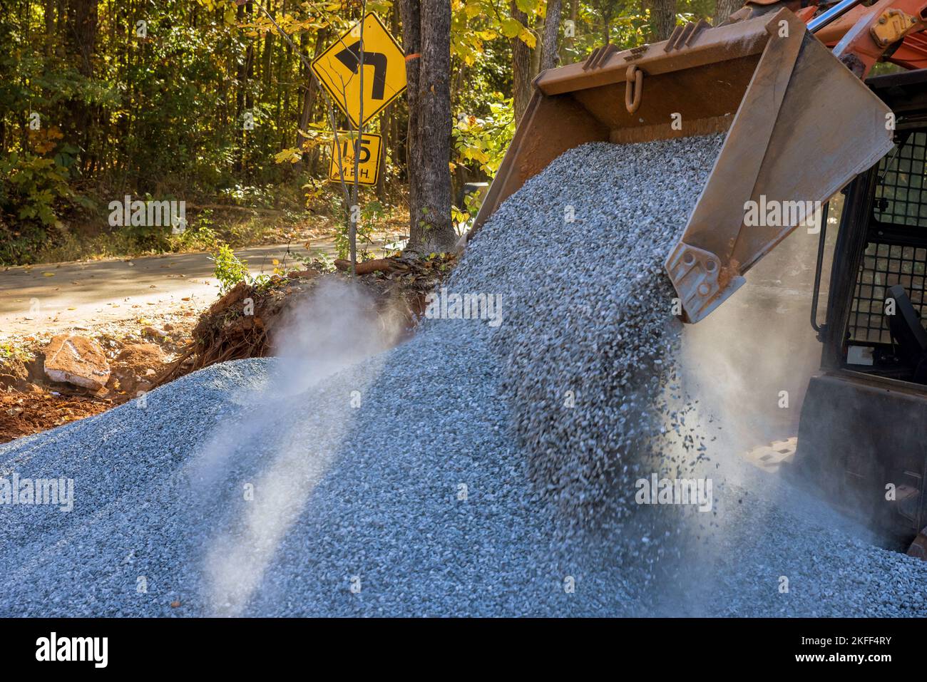 In unloading crushed stone on construction site during road repair ...