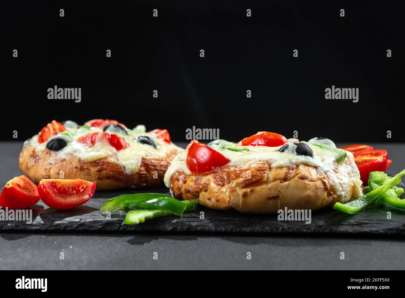 Homemade pizza with vegetables for breakfast on black background with ...