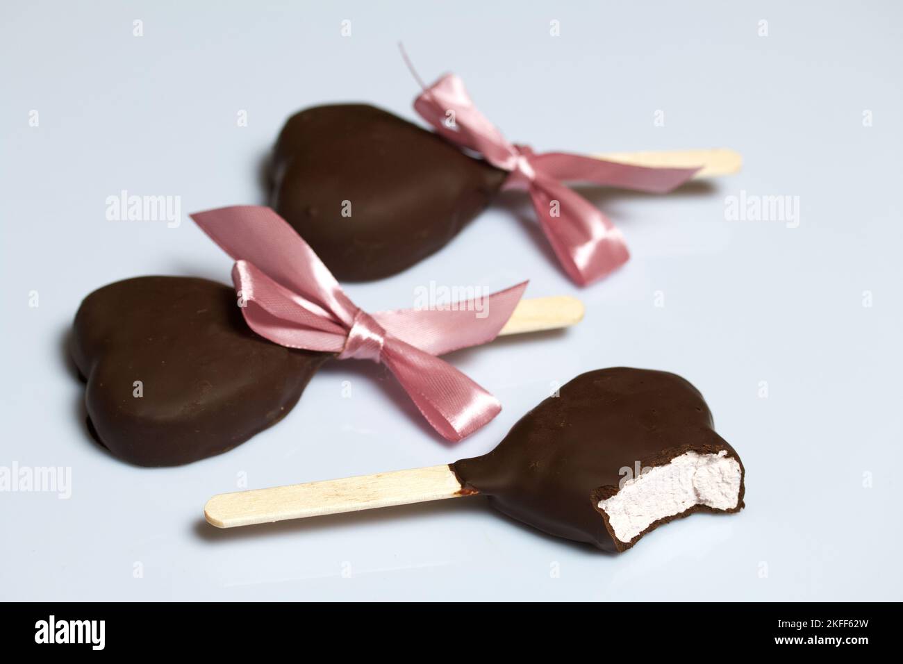 Marshmallows in chocolate on a stick. One bite. zephyr hearts glazed ...