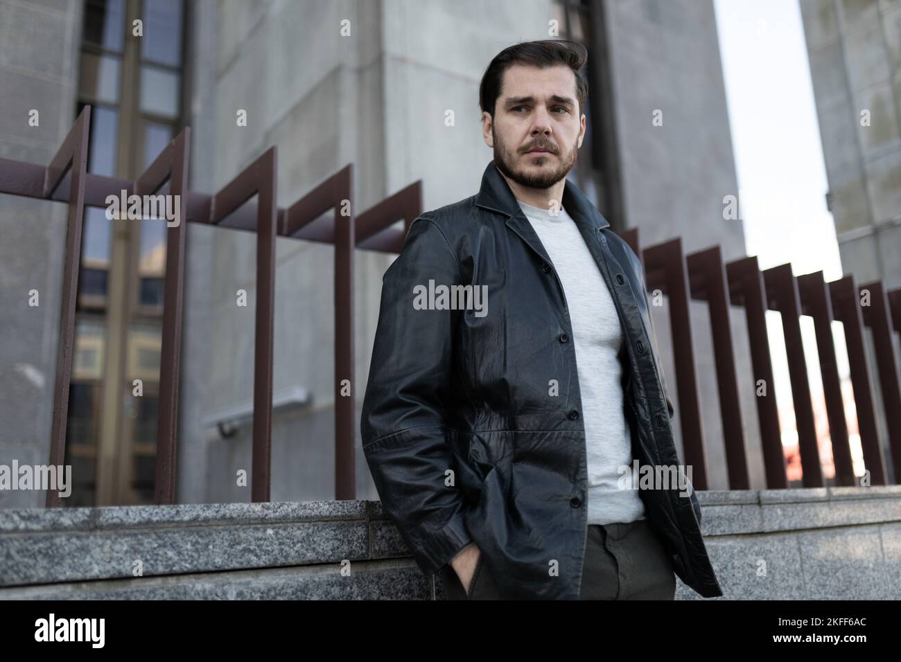 upset man with a sad expression on the background of a gray building ...