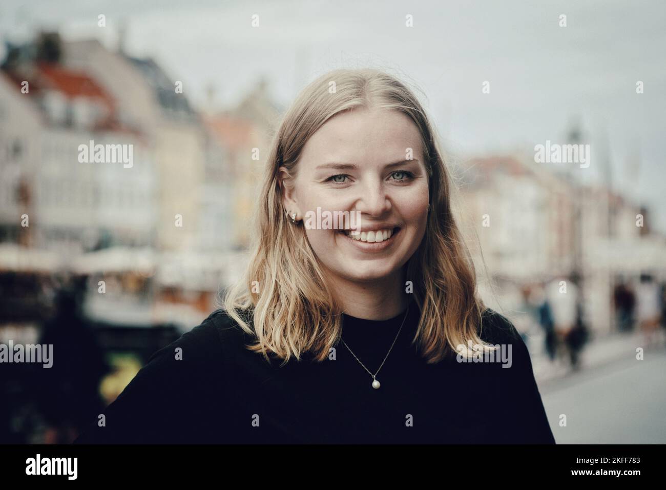 A beautiful blonde Caucasian woman portrait smiling at the camera in ...