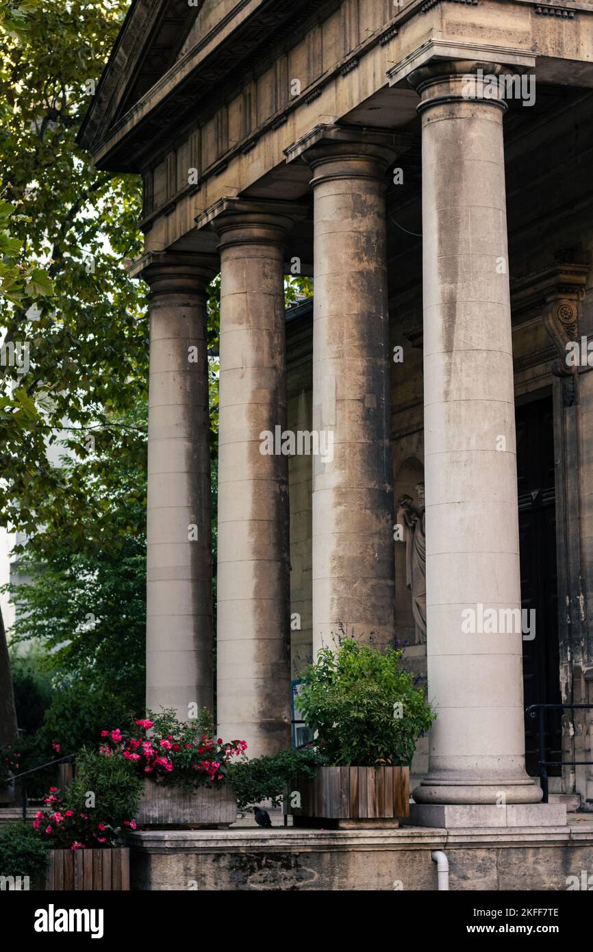 The vertical shot of a Roman-style architectural building's exterior ...