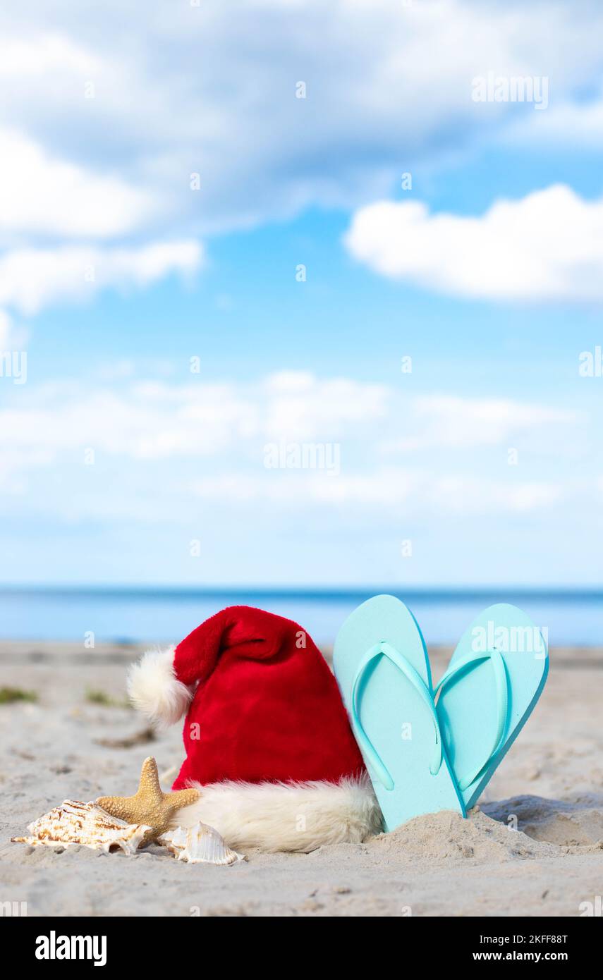Santa Claus hat on the beach with starfish,beach slippers Stock Photo ...
