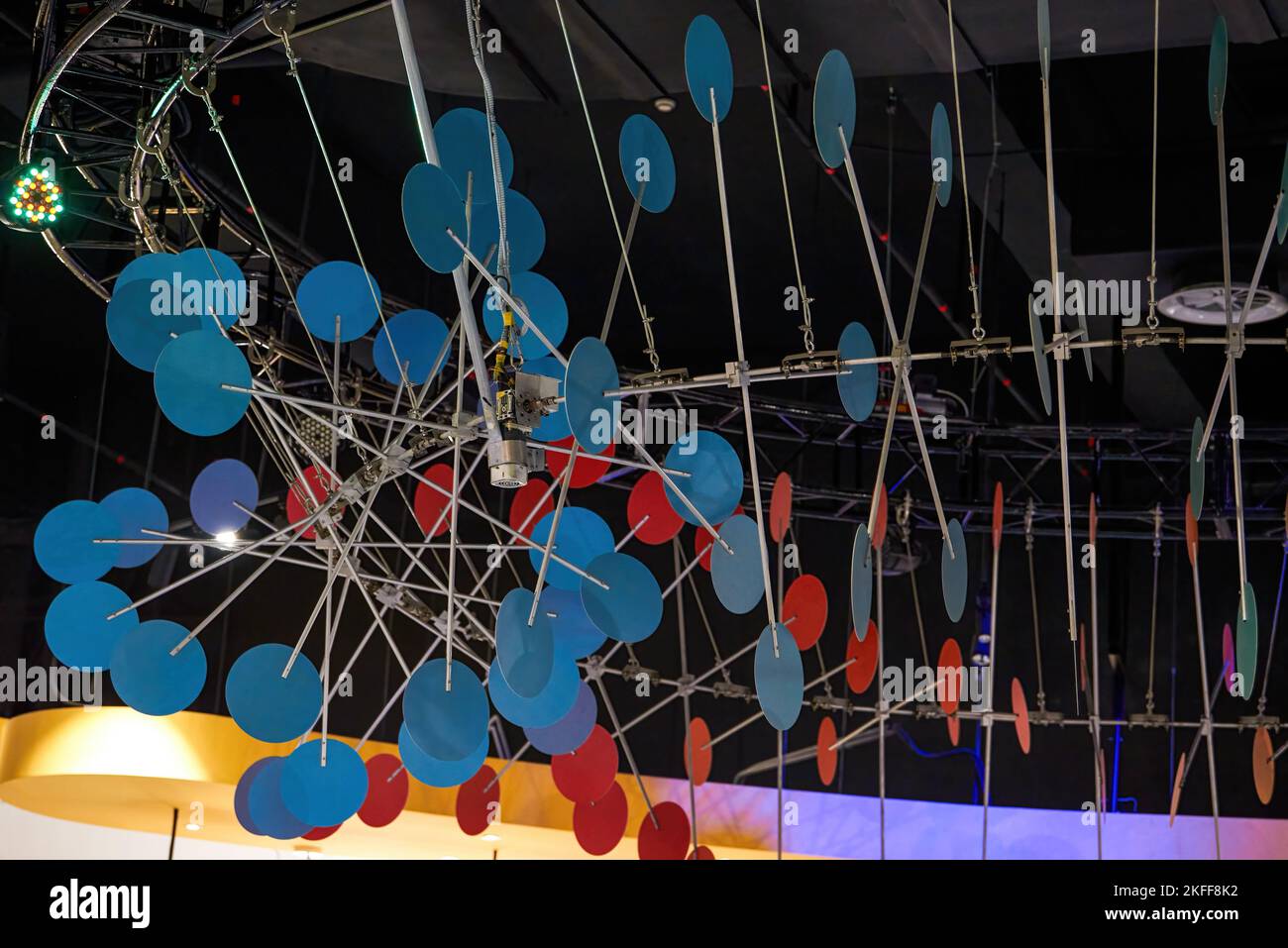 Colorful disc sculpture hanging indoors Stock Photo - Alamy