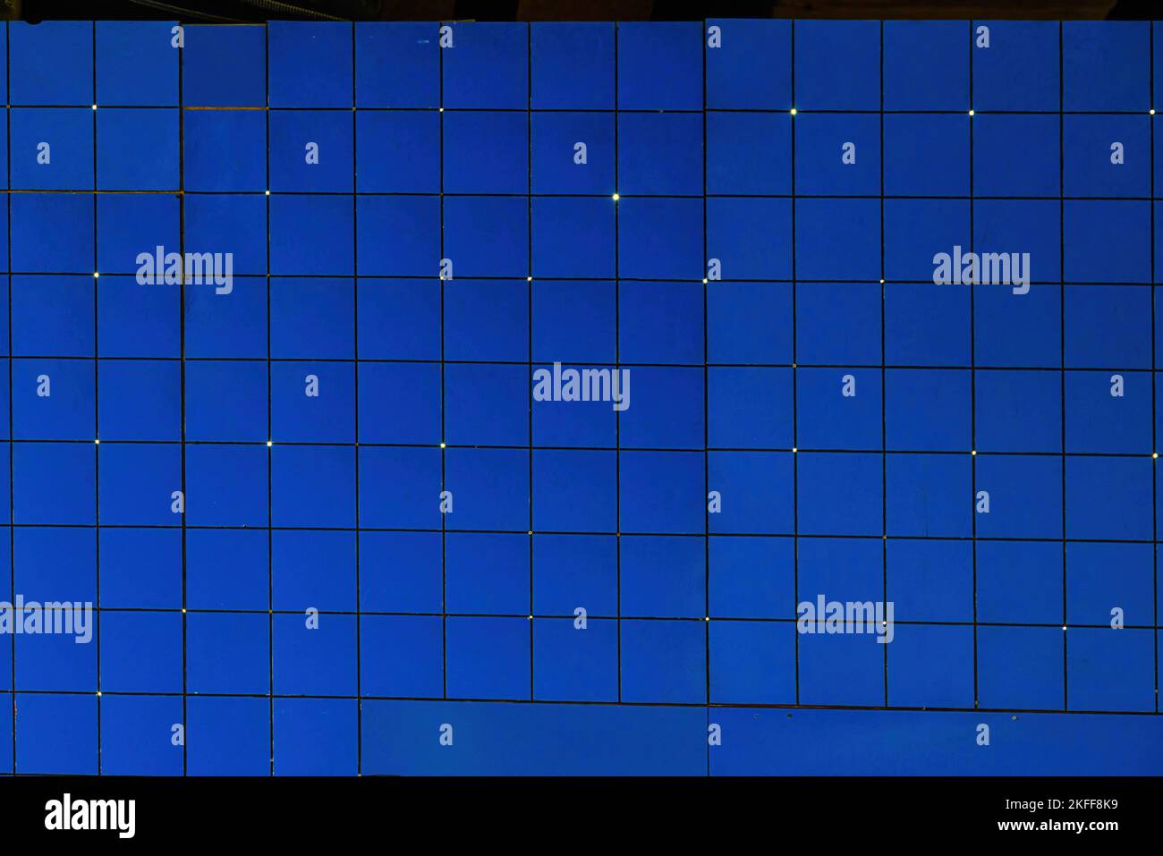 Regular wall full of blue squares close-up Stock Photo - Alamy