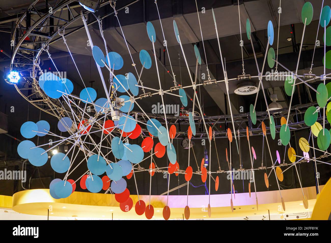 Colorful disc sculpture hanging indoors Stock Photo - Alamy