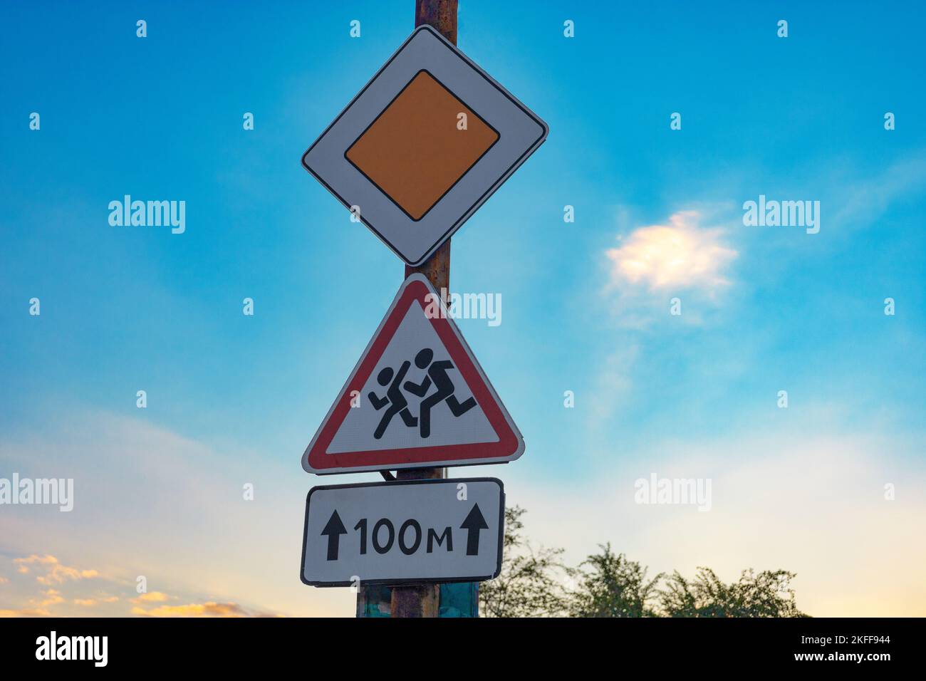 Road signs against the blue sky and brightly lit clouds in the ...