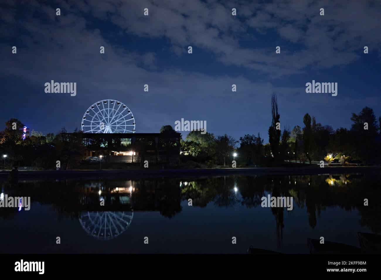 Observation wheel reflected in the lake Arevik, Monument park ...