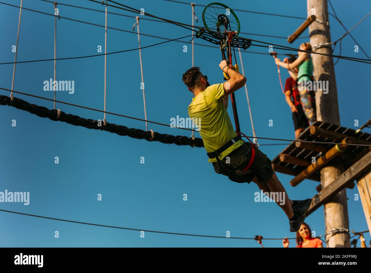 Adult man sitting on a pulley and rotating the wheel to go forward in ...