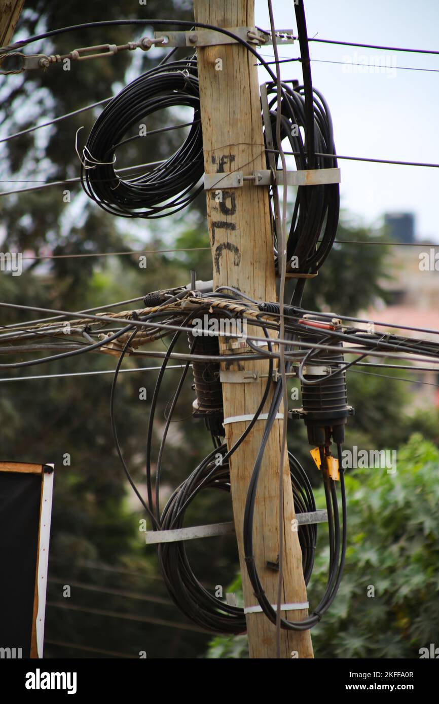 A vertical of the utility pole in Kenya, Nairobi with electric strings ...