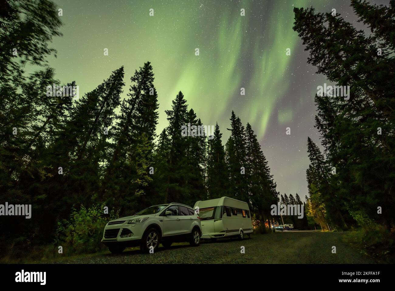 Aurora shining over Camping Caravan in Swedish forest landscape ...