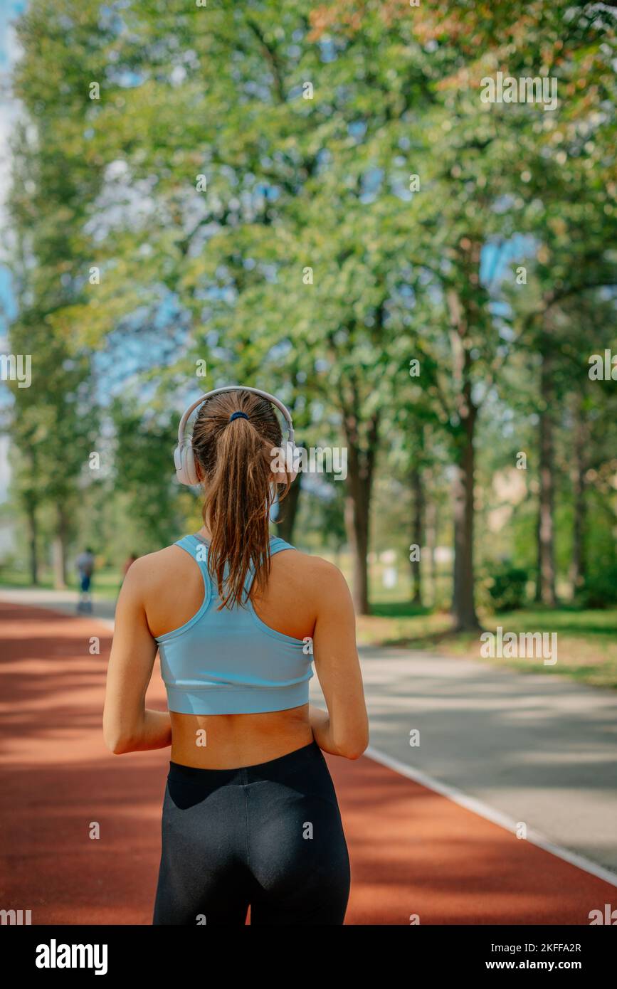Active sports girl with headphones on Stock Photo - Alamy