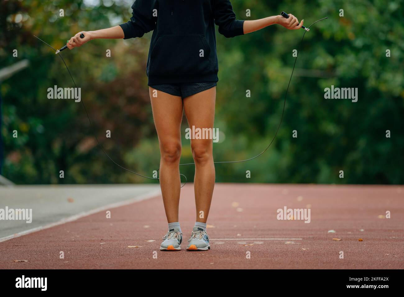 A photo of starting position of girl before jumping rope. Fit legs ...