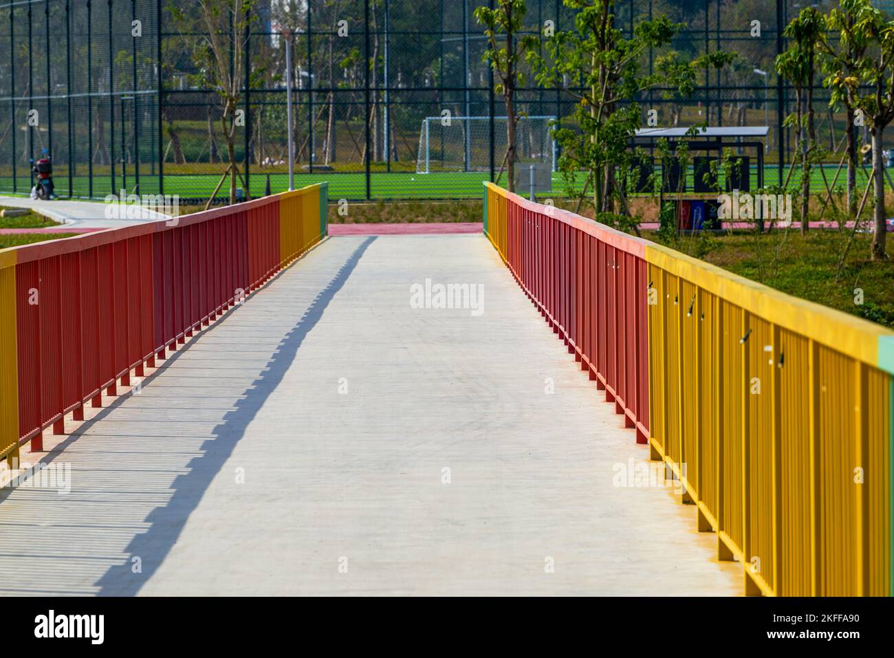 A pedestrian rainbow bridge over the city river Stock Photo - Alamy