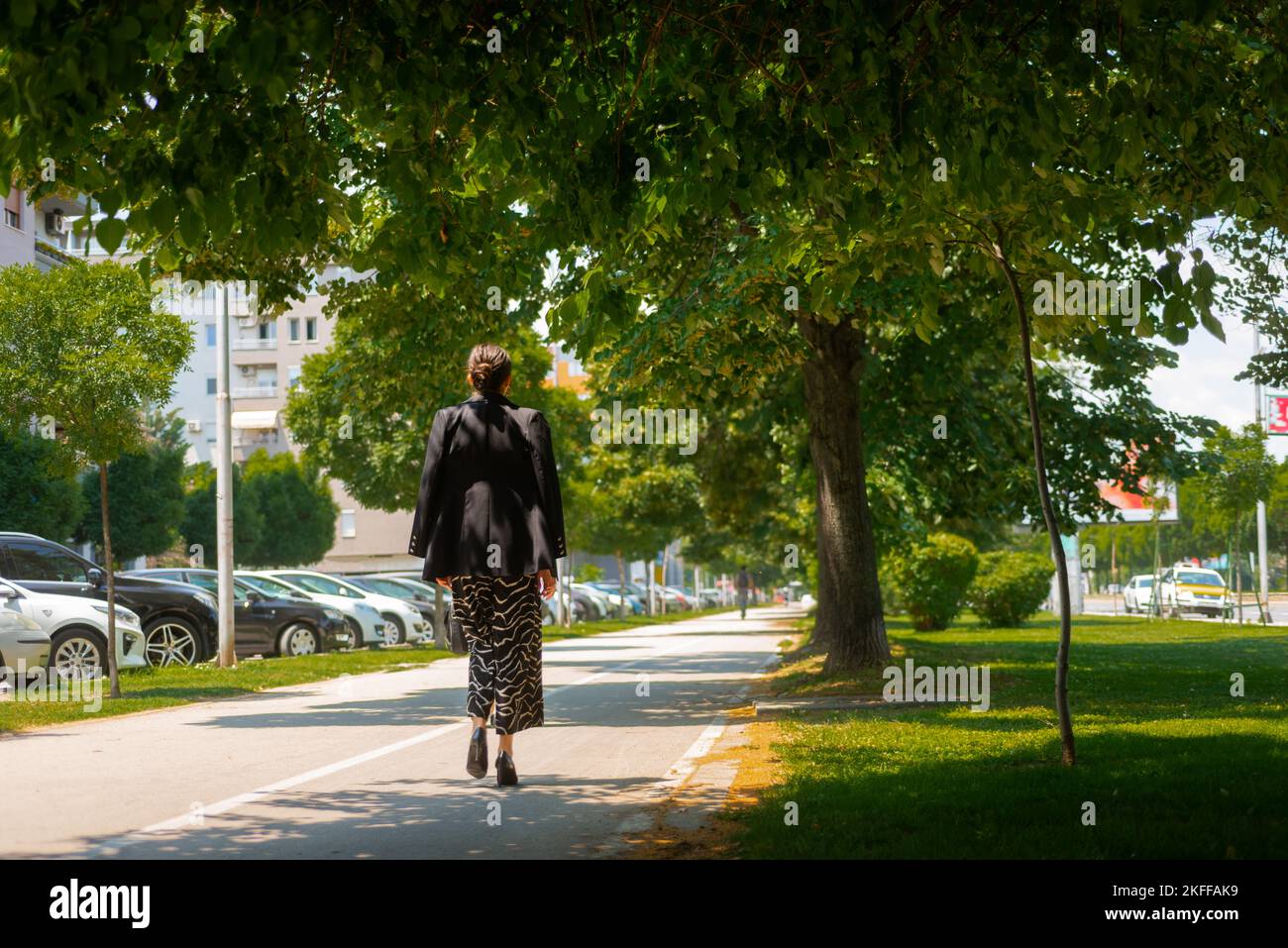 A gorgeous businesswoman finished with her daily tasks. She is going ...