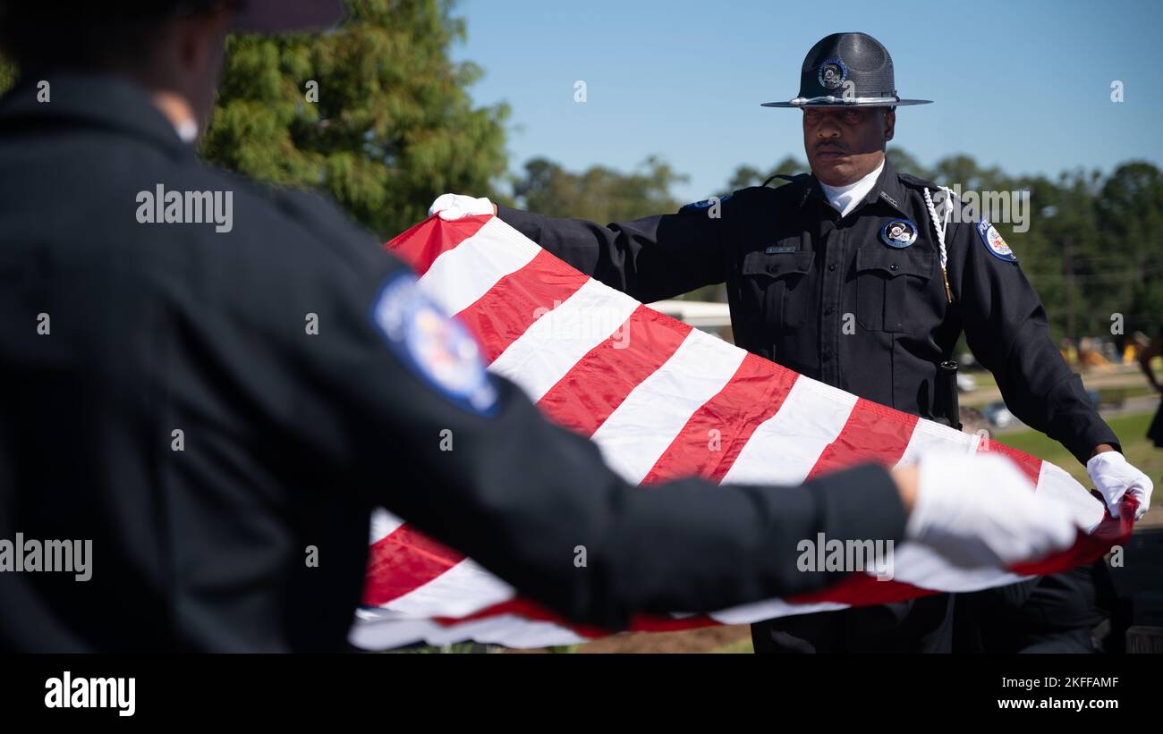 Members of the Mandeville Police Department Honor Guard unfold an ...