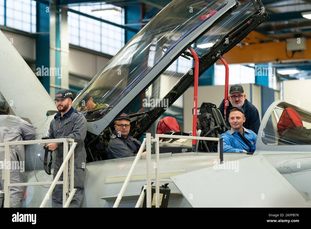 Aircraft engineers look on as The Prince of Wales in the BAE Systems ...