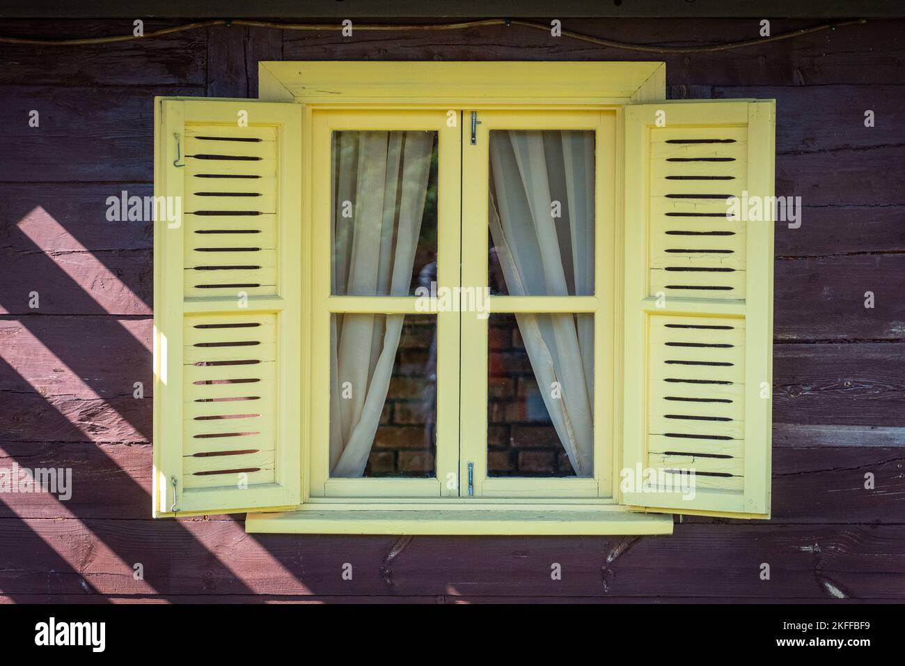 An old fashioned yellow window frame Stock Photo - Alamy