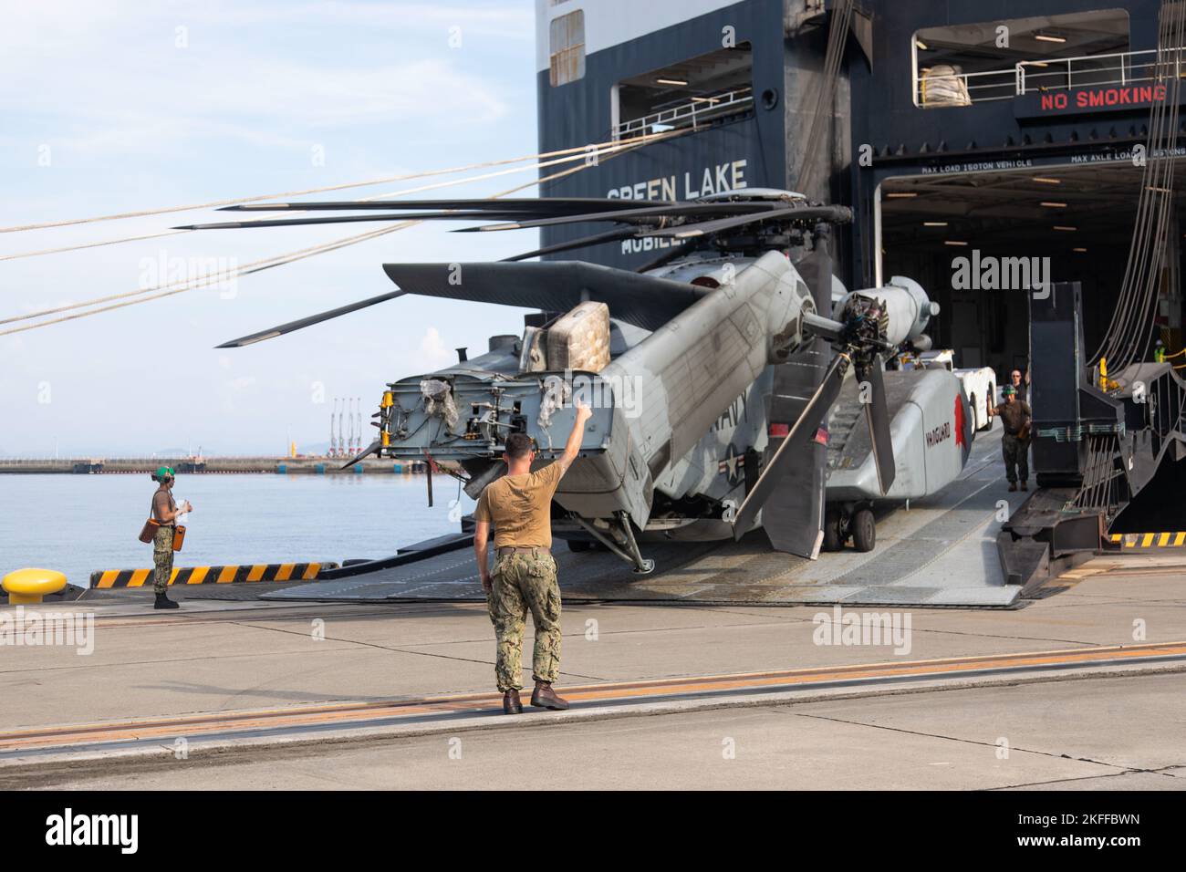 U.S. Navy Sailors with Helicopter Mine Countermeasures Squadron 14 unload an MH-53E Sea Dragon ...