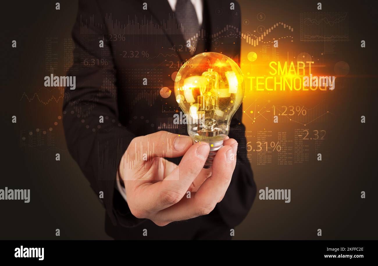 Businessman holding a lightbulb concept Stock Photo - Alamy