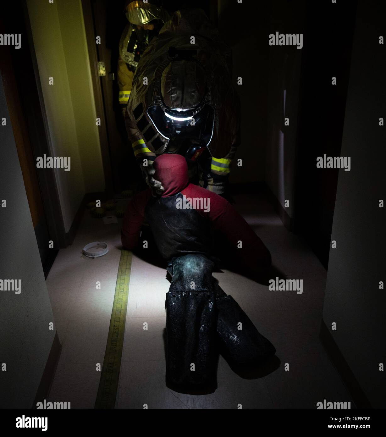 Firefighters assigned to the 51st Civil Engineer Squadron, drag a ...