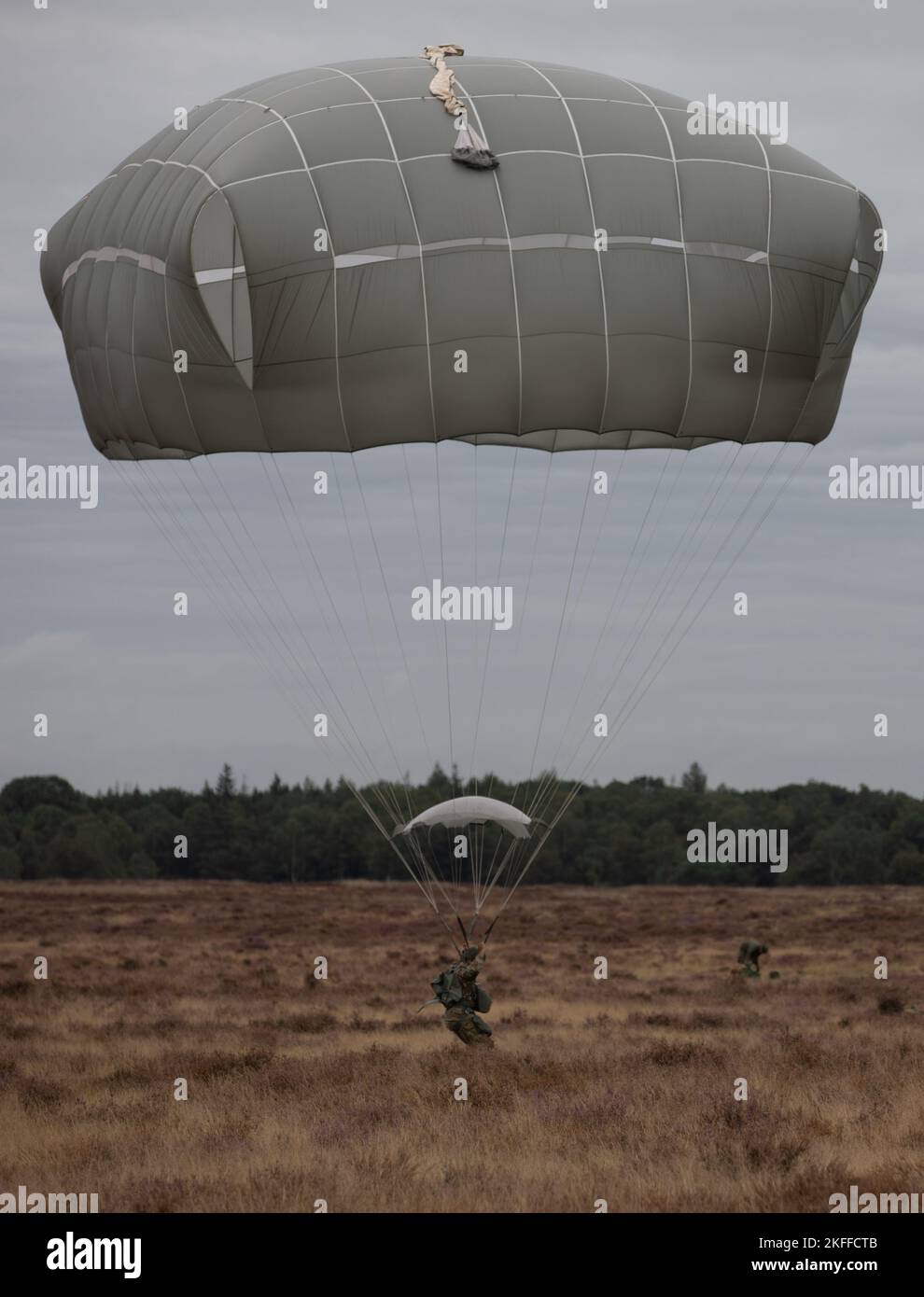 A U.S. Army Paratrooper decends to the Drop Zone using his T-11 ...