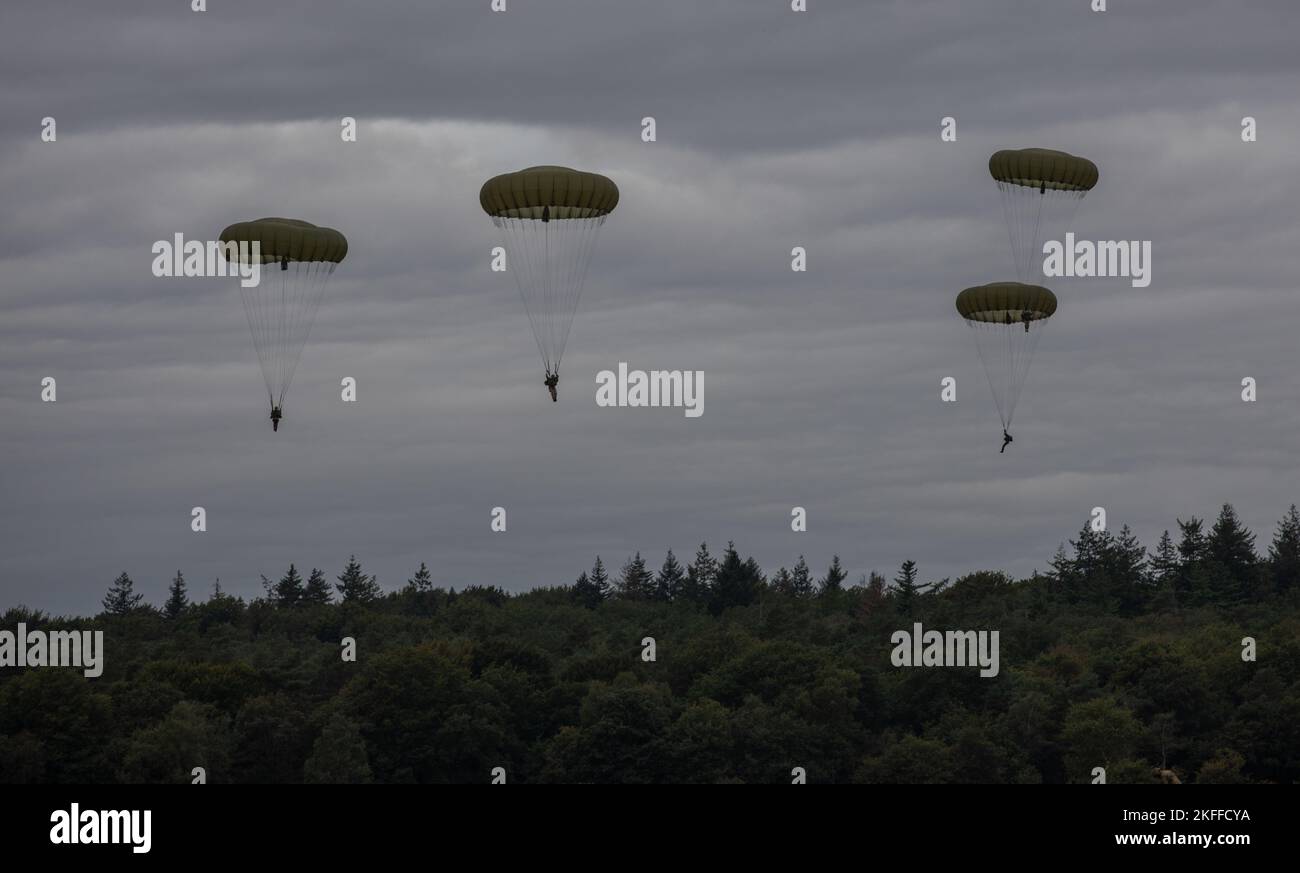 A group of U.S. Army and European Paratroopers decends to the Drop Zone ...