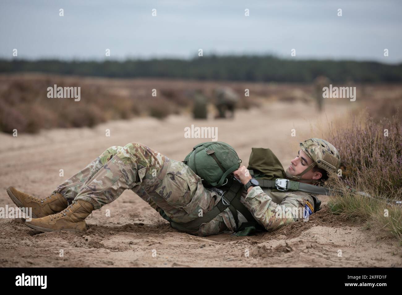 A U.S. Army Paratrooper derigs his German T-10 parachute after landing ...