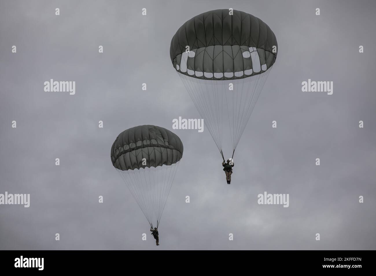 A group of U.S. Army and European Paratroopers decends to the Drop Zone ...