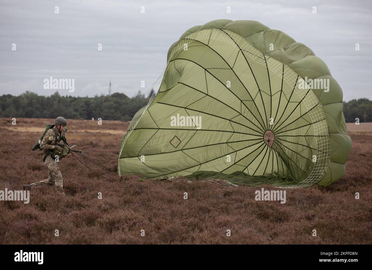 A Dutch Paratrooper gets dragged by his German T-10 parachute during ...
