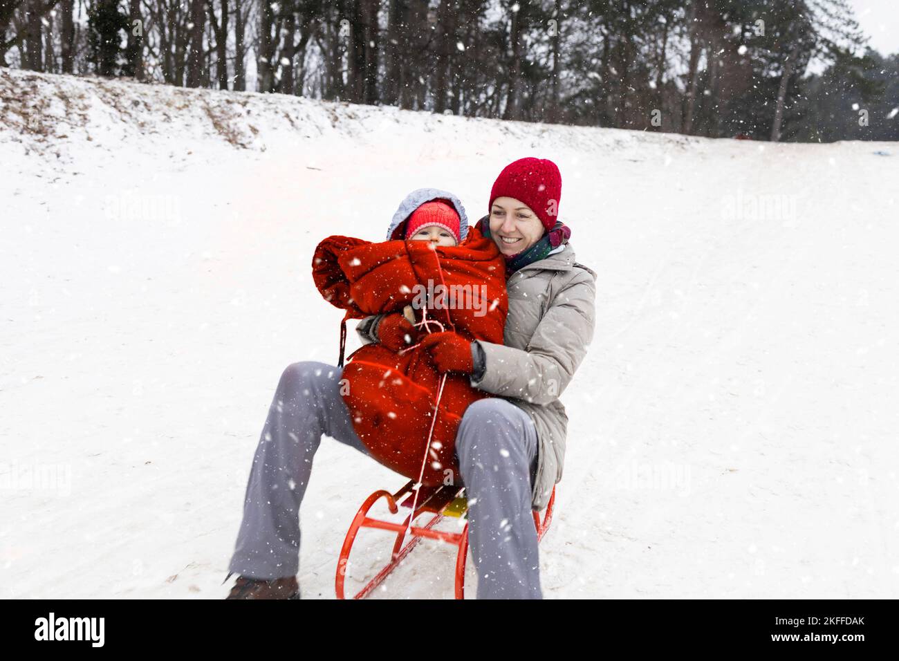 Mother and her daughter having fun in the snow Stock Photo - Alamy