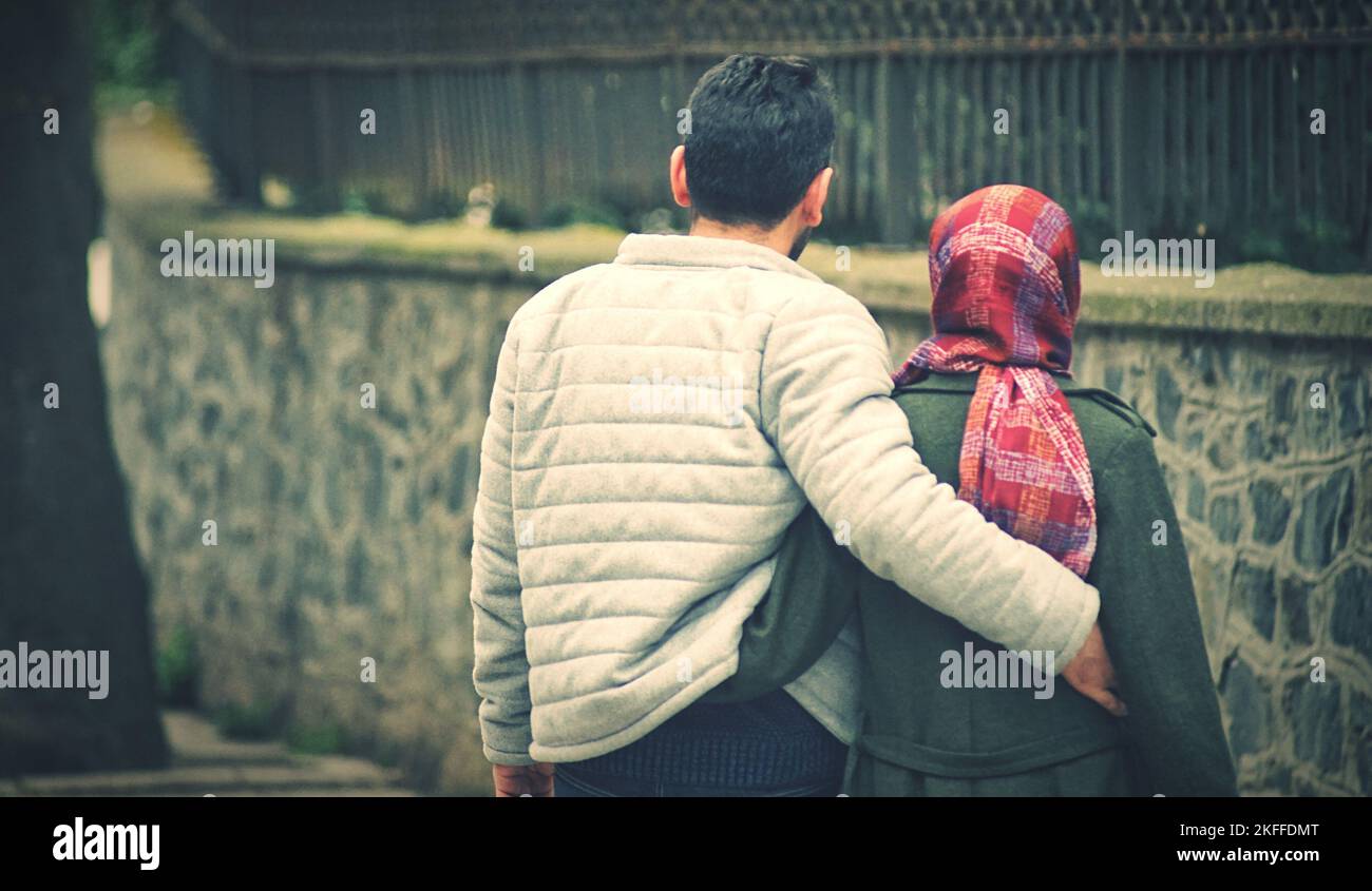 The view from behind of a Muslim couple hugging each other Stock Photo ...
