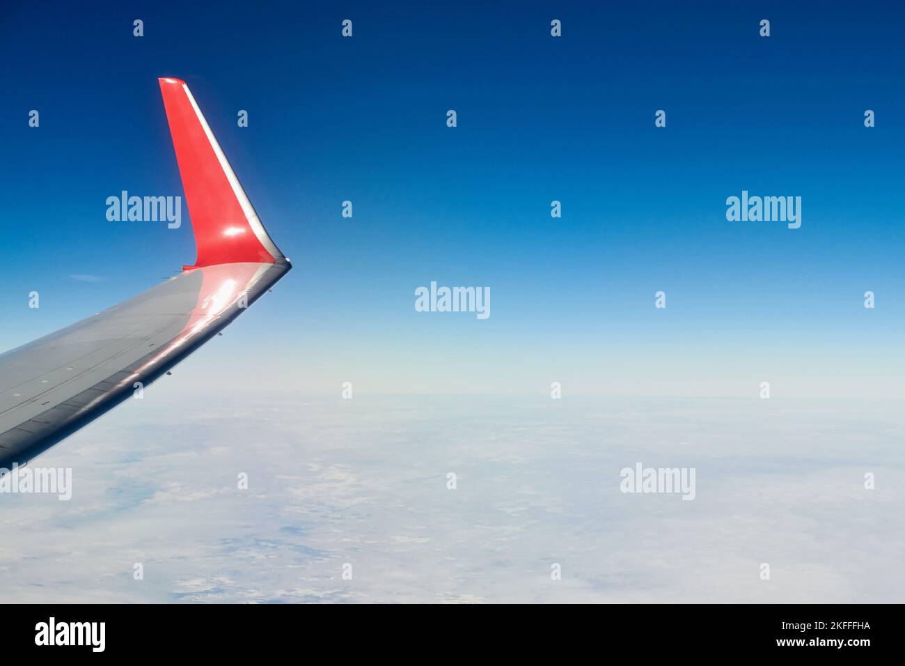 Airplane wing over clouds aerial top view from aircraft window, thick ...