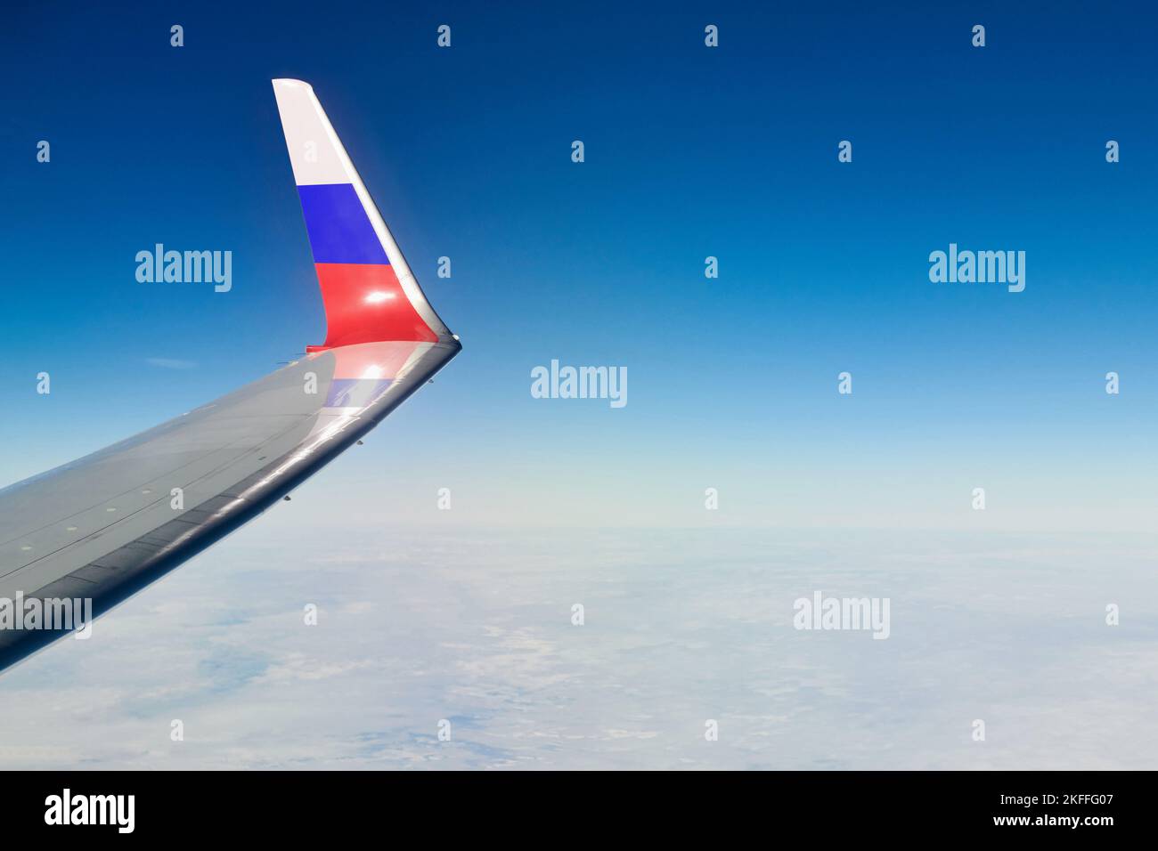 Airplane wing with Russian flag colors over clouds aerial top view from ...