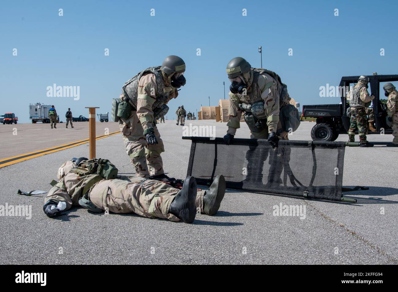U.S. Air Force Airmen prepare to secure a simulated casualty on a ...