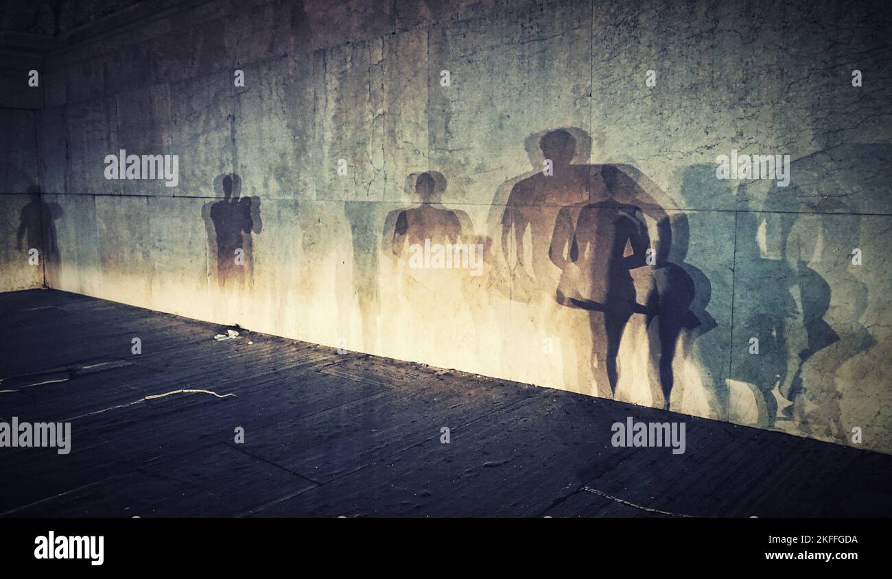 The shadows of people on the gray wall of a basement Stock Photo - Alamy