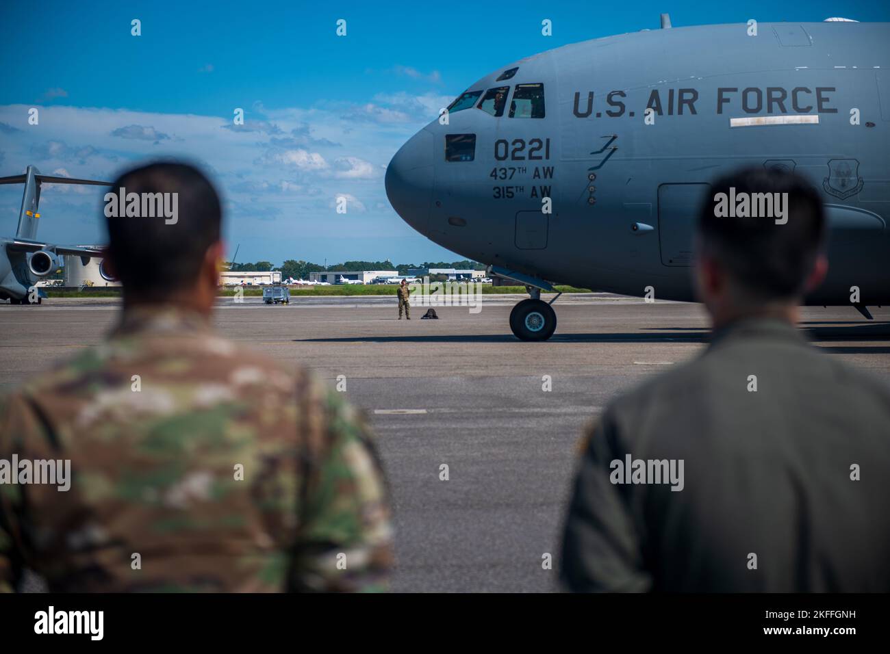 U.S. Air Force Airmen stand on the flightline as Maj. Gen. Corey J ...