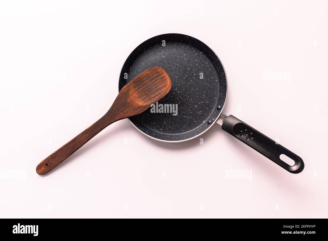 iron pan with wooden spatula top view isolated on white background ...