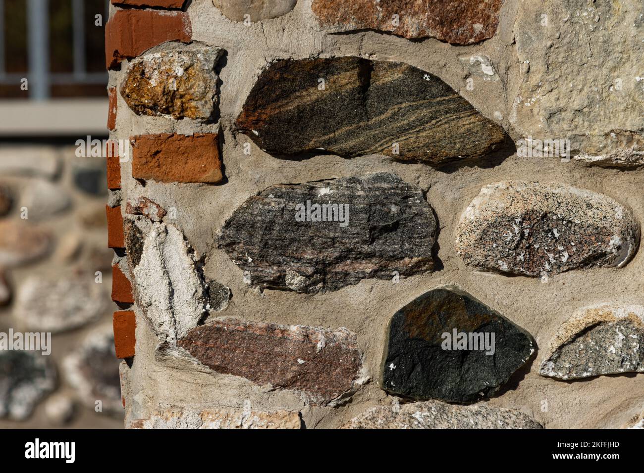 Remnants of a stone wall mixed with cement, with granite and gneiss ...