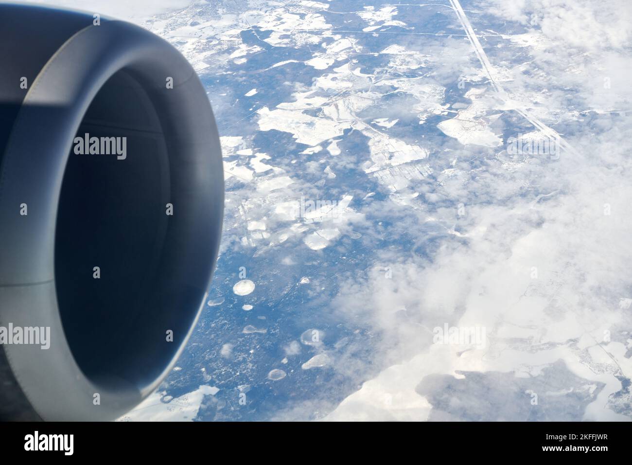 Aerial view from airplane window over clouds top to aircraft turbine ...