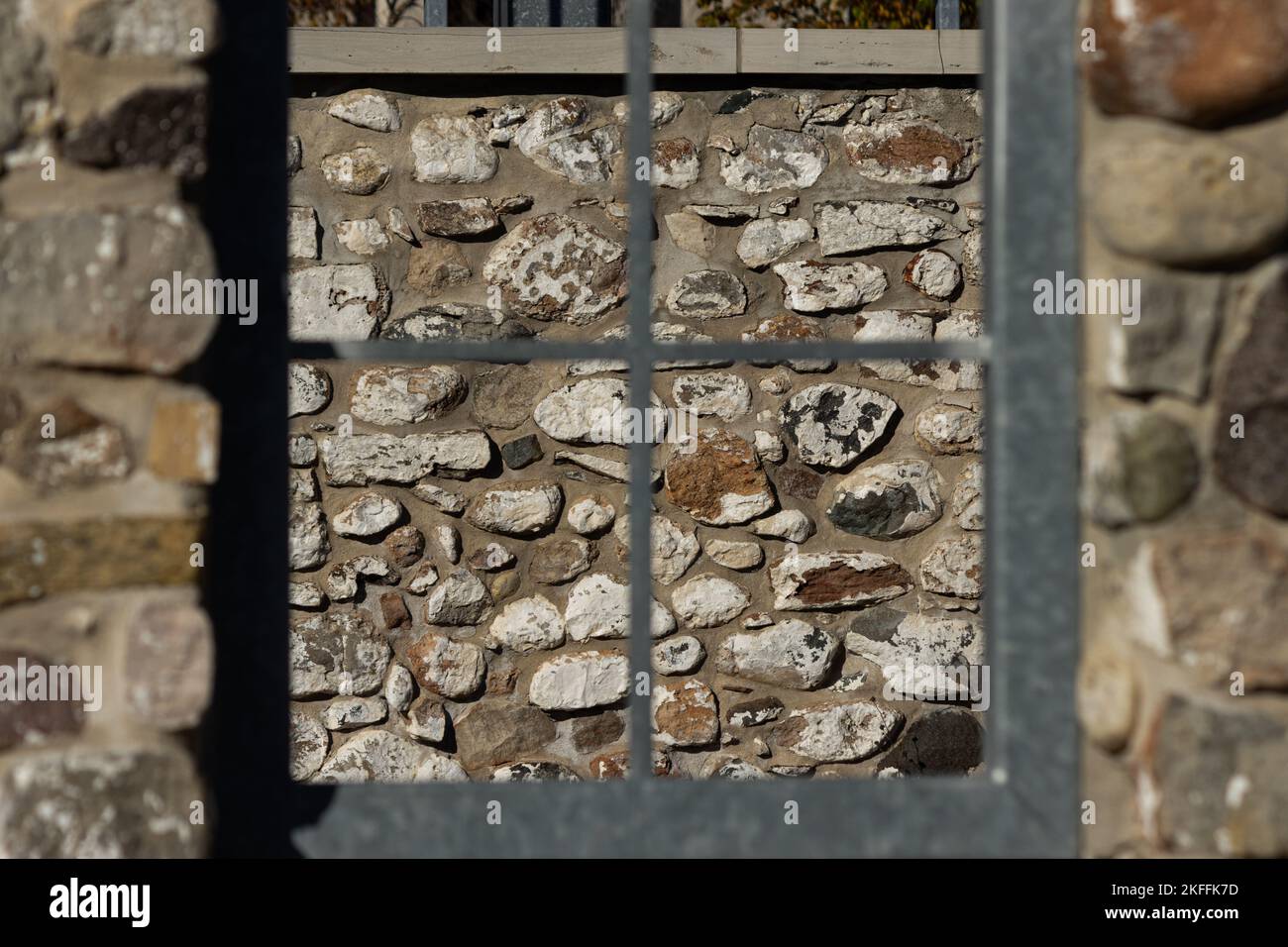 Remnants of a stone wall mixed with cement, view through an empty ...