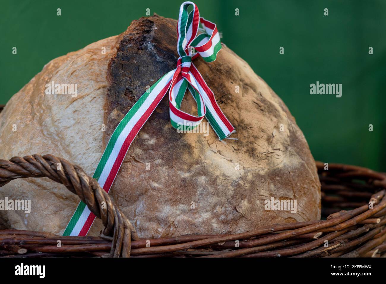 A freshly baked loaf of rustic bread in a basket at the the time of the ...