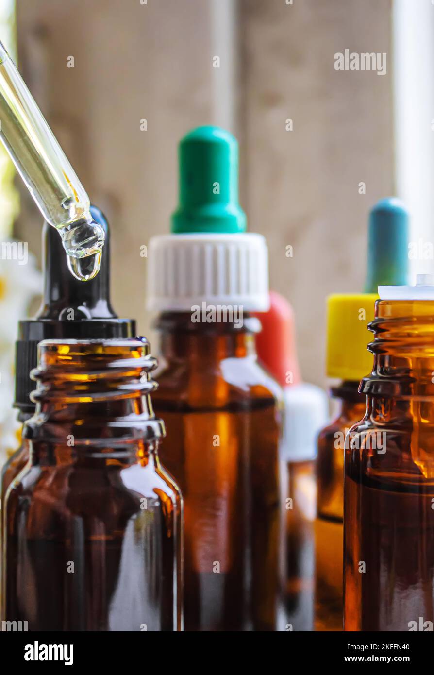 Medicinal herbs in bottles. chamomile oil extract. Selective focus ...