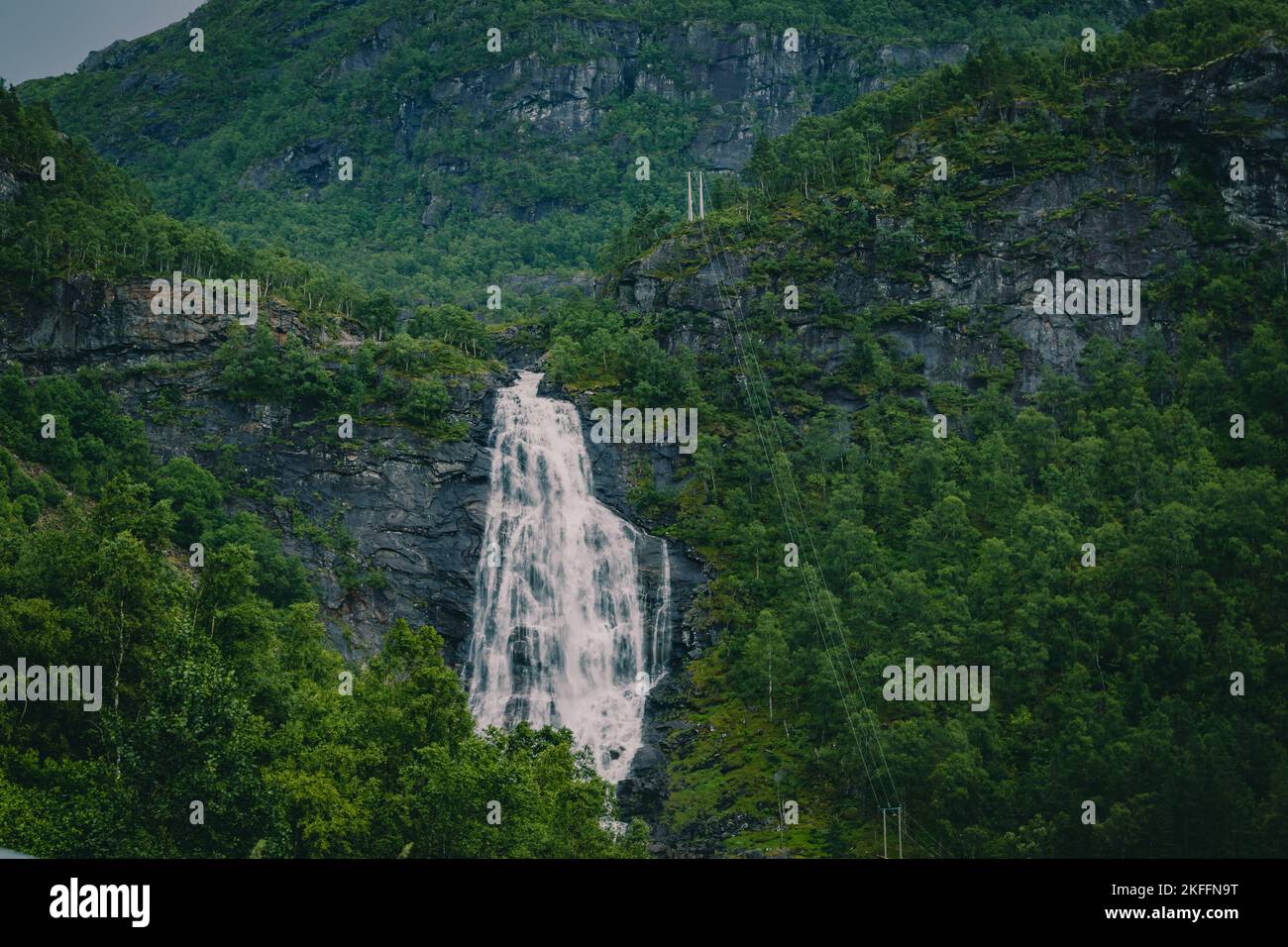 A long exposure shot of a waterfall in a valley emerging from the ...