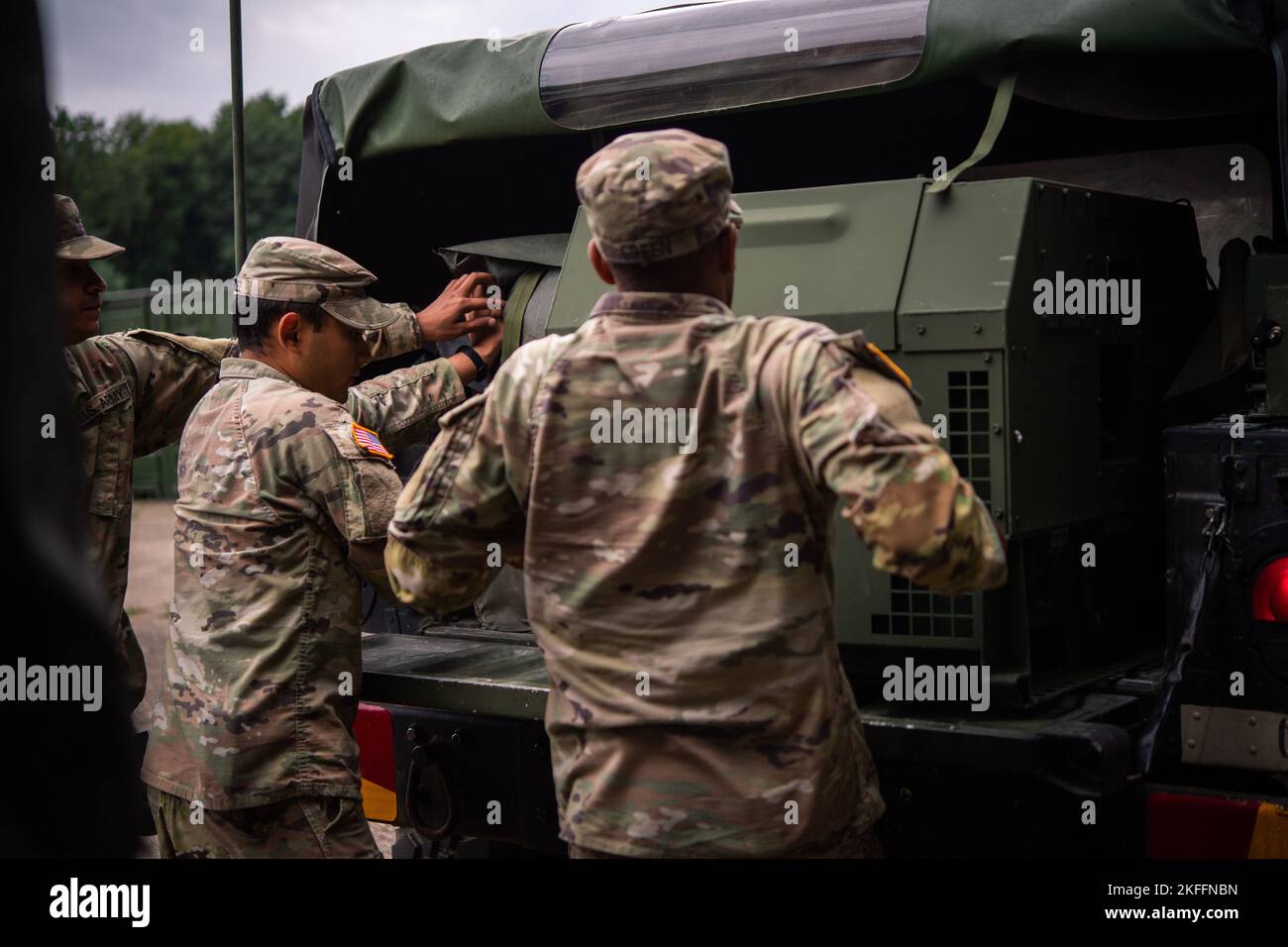 U.S. Army soldiers assigned to the 44th expeditionary signal battalion, pull a generator from ...