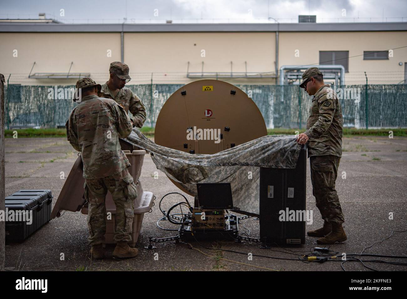 U.S. Army soldiers assigned to the 44th expeditionary signal battalion, create a shelter from ...