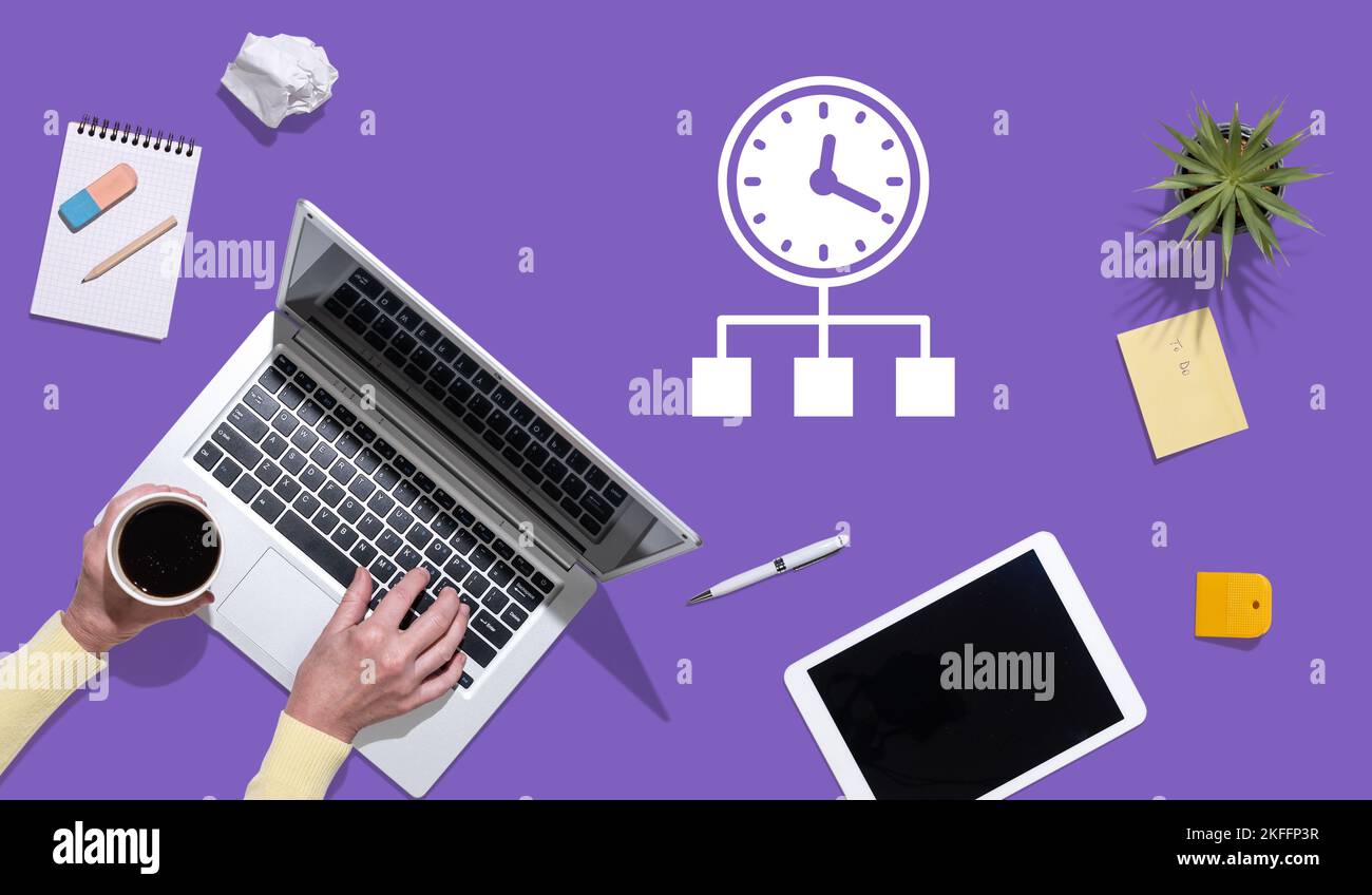 Top view of hands using laptop with symbol of time management concept ...